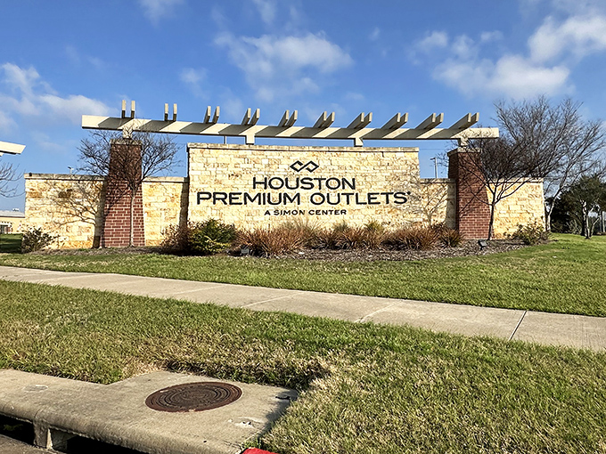 The Houston Premium Outlets sign stands as a retail Statue of Liberty, welcoming the tired, poor, and fashion-hungry masses yearning for a good deal.