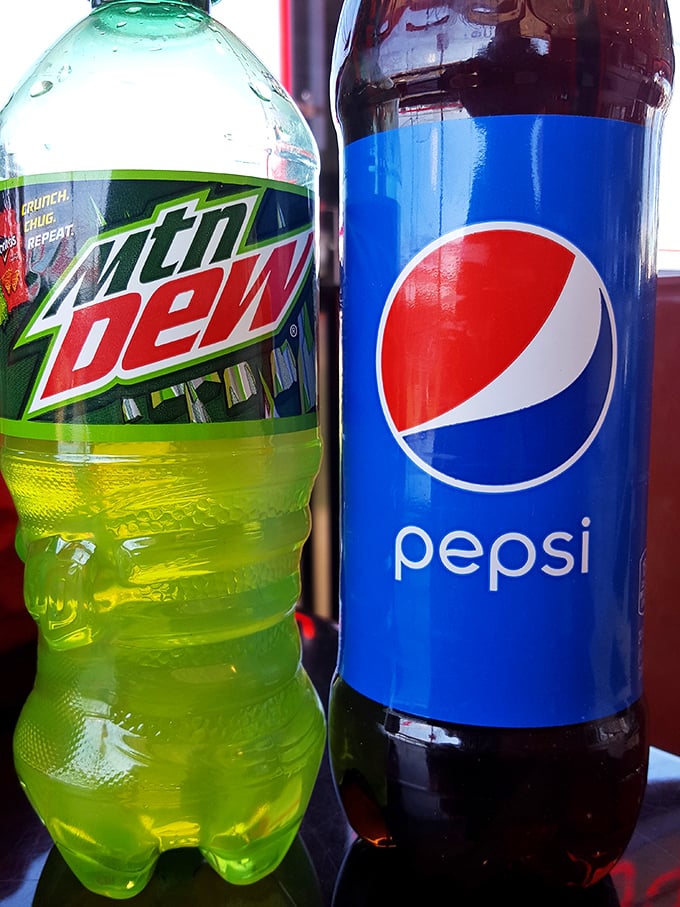 The classic beverage duo—Mountain Dew's electric green alongside Pepsi's deep brown, ready to wash down whatever deliciousness you've ordered.