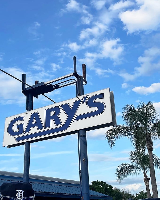 The iconic Gary's sign against a perfect Florida sky—a beacon of hope for hungry travelers seeking authentic seafood.