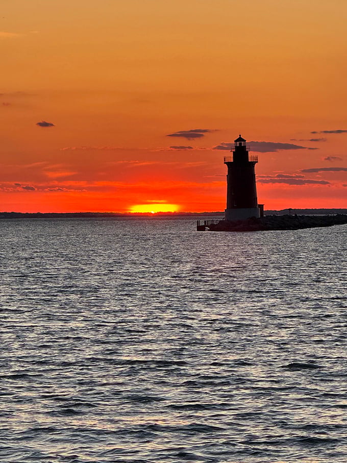 Nature's light show upstages the lighthouse at sunset. Even after centuries of maritime service, this beacon knows when to share the spotlight.