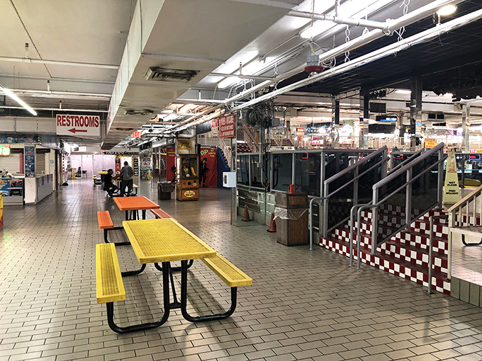 The food court's picnic tables—neutral territory where tired shoppers refuel before diving back into the retail wilderness. Strategic planning happens here.