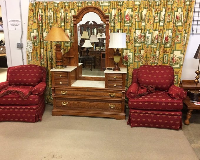 This vanity setup with matching burgundy chairs isn't just furniture—it's a time machine to when getting ready was an event, not a rushed morning ritual.