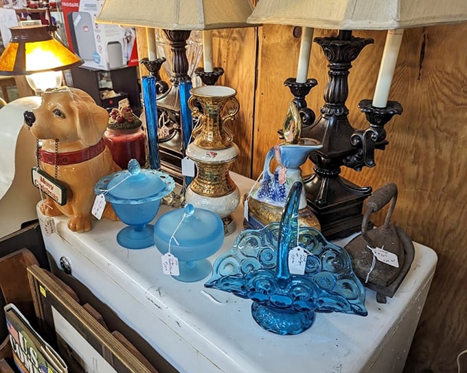 Blue glass and vintage candelabras share space with a ceramic dog—a delightful jumble that perfectly captures the "you never know what you'll find" spirit.