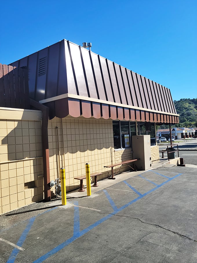 The exterior view reveals the shop's humble charm—brown awnings against beige walls, where culinary magic happens without pretension or fanfare.