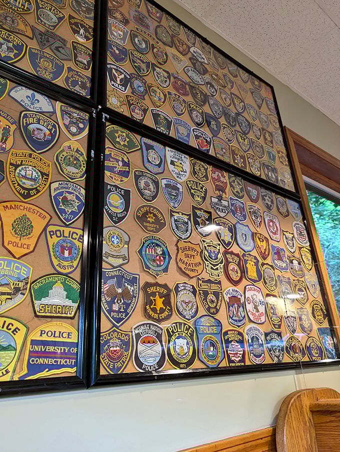 The wall of police and fire department patches tells stories of first responders who've found comfort here between calls. Diner décor with meaning.