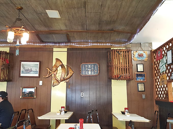 Stained glass fish art watches over diners like an aquatic guardian angel. The wood-paneled walls have absorbed decades of seafood satisfaction.