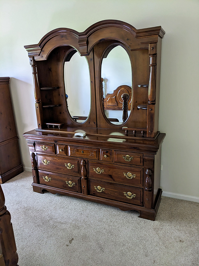 This wooden dresser with mirror isn't just furniture—it's a time machine to when craftsmanship meant something and drawers actually stayed on track.