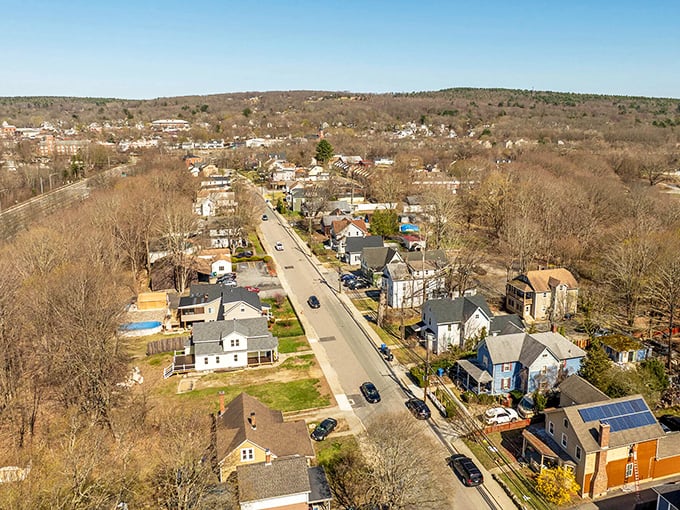 An aerial view of Brooklyn, Connecticut shows its peaceful residential streets nestled among rolling hills, offering affordable small-town charm.