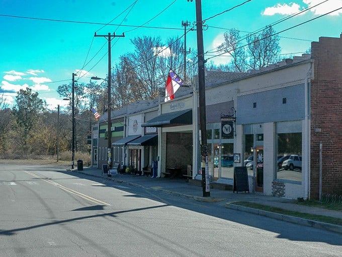 Hillsborough's charming main street showcases historic storefronts under bright blue skies, perfect for a small-town movie scene where characters discover local treasures.