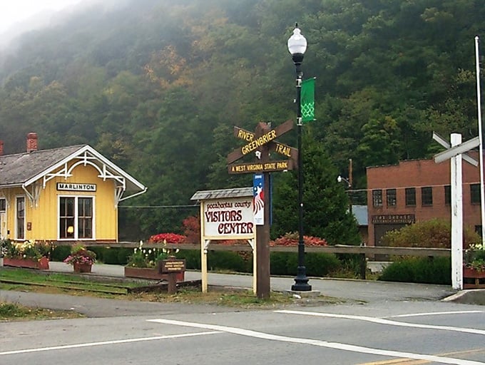 The cheerful yellow Marlinton train depot welcomes visitors at the Greenbrier River Trail entrance. Like a sunny landmark that's been giving directions since your grandparents wore hiking boots.