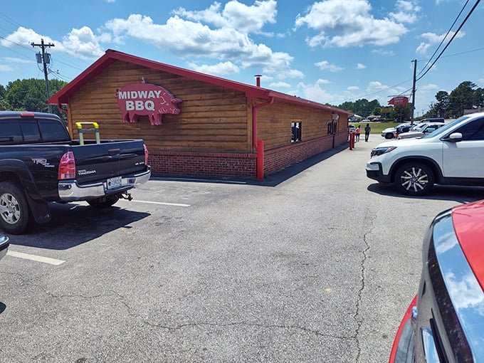 That hanging red pig sign at Midway BBQ isn't just cute – it's a landmark guiding hungry travelers home since 1941.