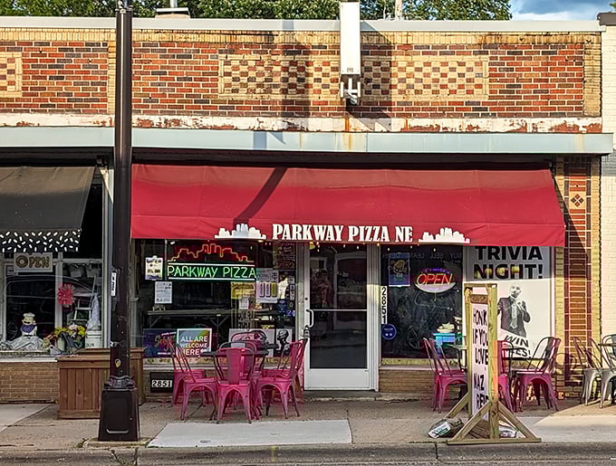 The bright red awning and colorful outdoor seating announce a pizza place that's serious about flavor but doesn't take itself too seriously.