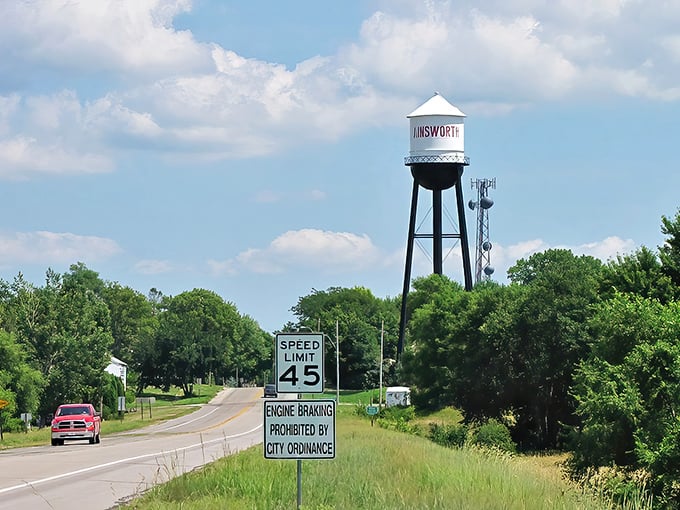 Ainsworth announces itself with a water tower that stands like a friendly lighthouse guiding travelers home across the prairie sea.