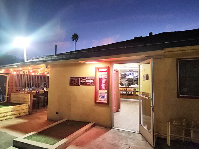 Night falls but the smoker's still going! Best Bar-BQ's simple storefront transforms into a beacon for hungry travelers as evening arrives.
