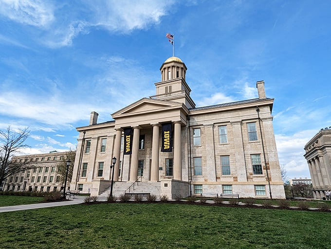 The Old Capitol in Iowa City shines proudly with its golden dome, celebrating tradition, learning, and Hawkeye pride under clear skies.