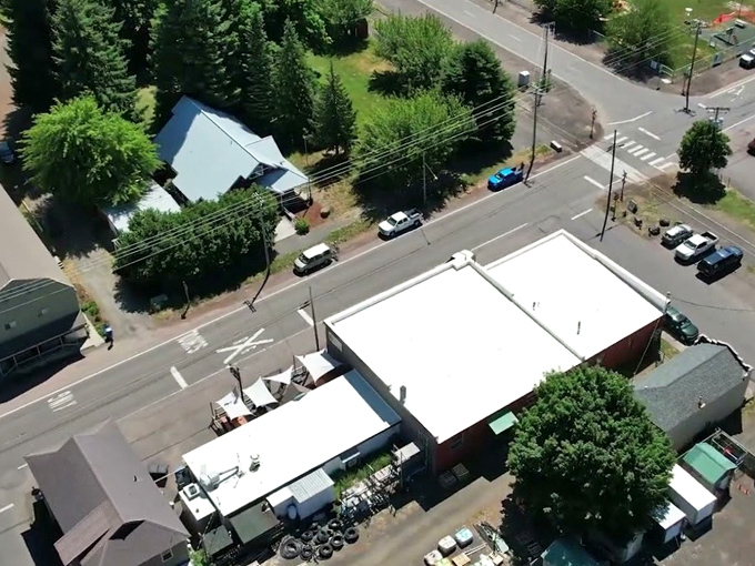 An aerial view of Parkdale reveals a quiet crossroads town framed by evergreens—small in size but surrounded by big Oregon scenery.