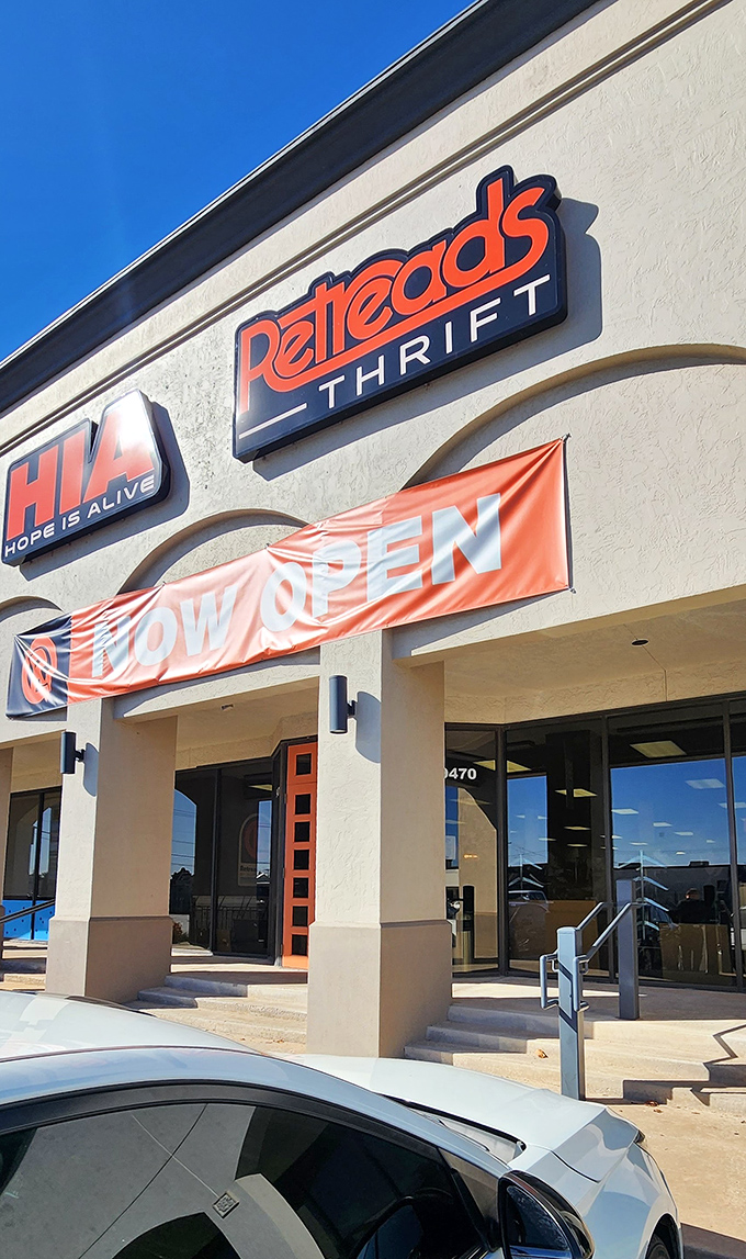 The "Now Open" banner waves like a victory flag for bargain hunters across The Village.
