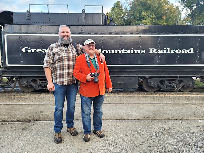 We came, we saw, we trained! Happy travelers capture their railroad memories against the iconic Great Smoky Mountains Railroad tender.