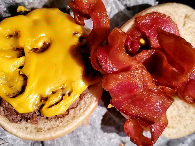 A burger that speaks the universal language of comfort—melted cheese cascading over a juicy patty with bacon standing by for reinforcement.