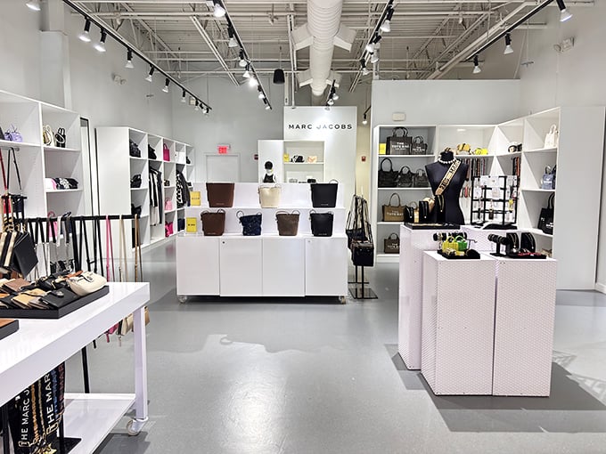 Marc Jacobs' minimalist display showcases the art of temptation. White pedestals elevate handbags from accessories to museum-worthy treasures.