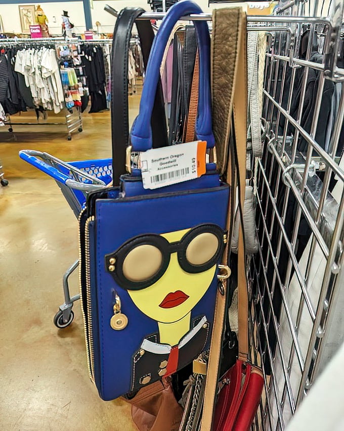Handbags with personality hang in patient formation. That blue face purse isn't just an accessory—it's wearable art waiting for its perfect match.