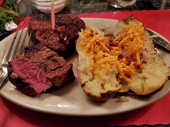 Medium-rare perfection meets loaded baked potato—a classic American duet performing their greatest hits on a simple white plate.