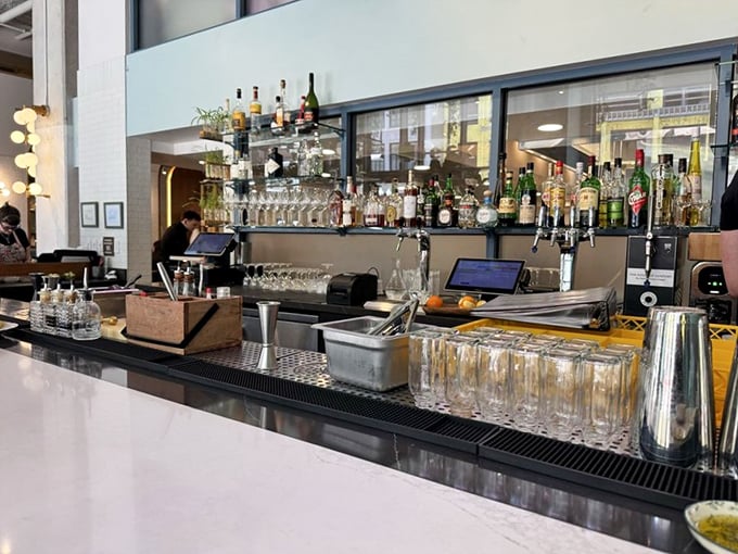 The bar at Speck isn't just where drinks are made—it's command central for liquid happiness, with enough bottles to survive any apocalypse in style.