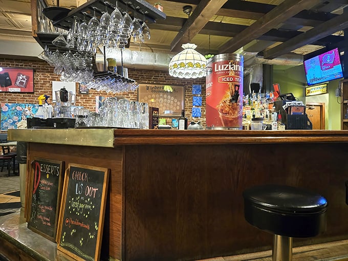 Behind the bar, where the magic happens—vintage lighting, exposed brick, and a bartender ready to pour your favorite libation.