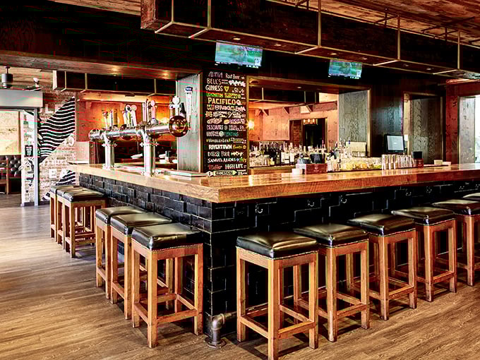 A bar built for lingering, where craft beers flow and strangers become friends over shared plates of southern comfort classics.