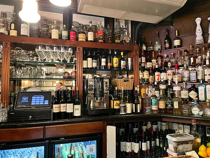 A bar stocked like a liquid museum – where every bottle tells a story and the bartenders know all the best chapters.
