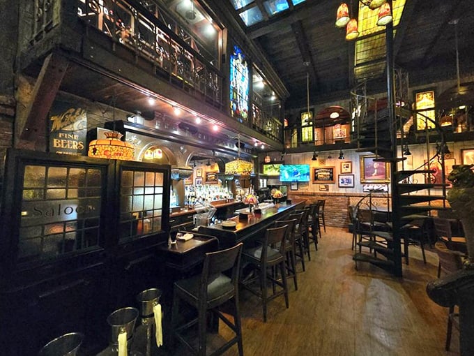 The bar isn't just where drinks are served – it's a cathedral of conviviality, with stained glass windows illuminating conversations that flow as smoothly as the bourbon.