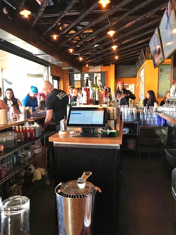 The bar area buzzes with activity – because nothing complements smoked meats quite like a cold beverage and sports on multiple screens.