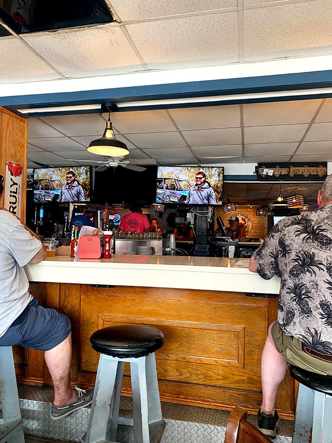 The bar—where locals exchange fishing tales and visitors become temporary locals over cold drinks and hot seafood.