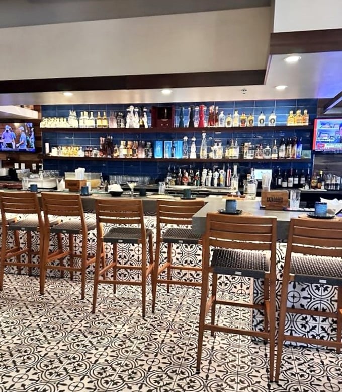 The bar at Agave Azul isn't just stocked—it's a tequila library with shelves of bottles backlit in blue, promising spirited adventures for curious palates.
