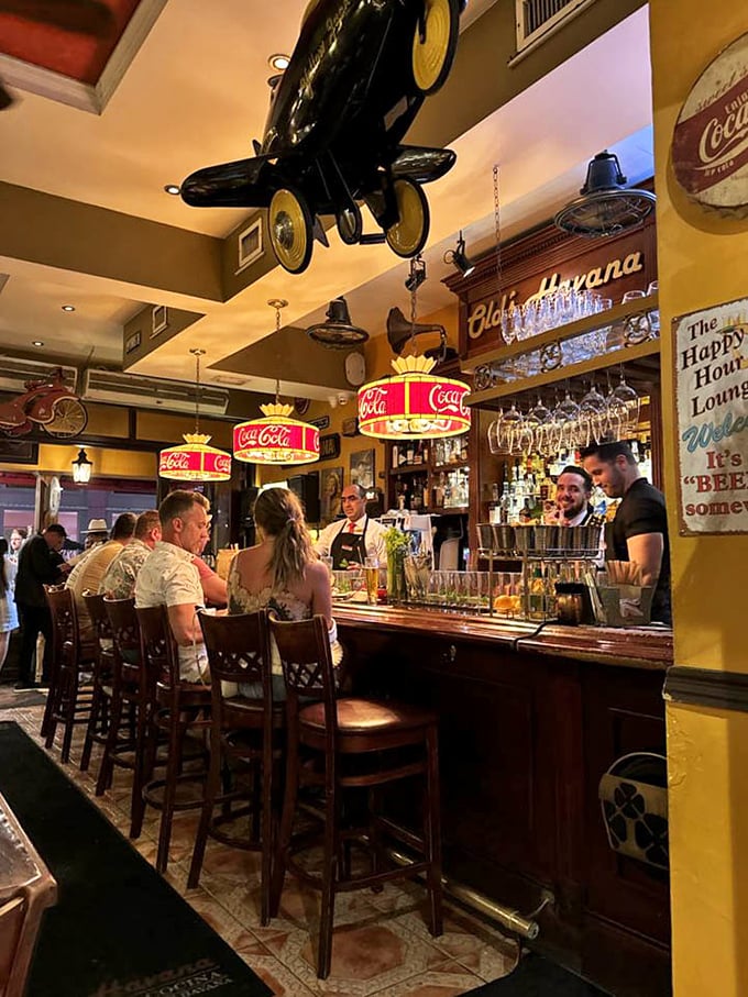 Coca-Cola chandeliers illuminate the bar where magic happens—one part rum, two parts conversation, and a splash of Cuban hospitality.