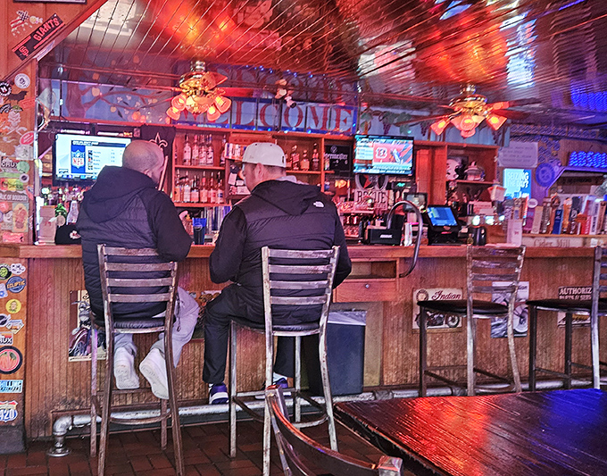 The bar area glows with neon warmth, where locals perch on stools that have supported generations of Portland chicken enthusiasts.