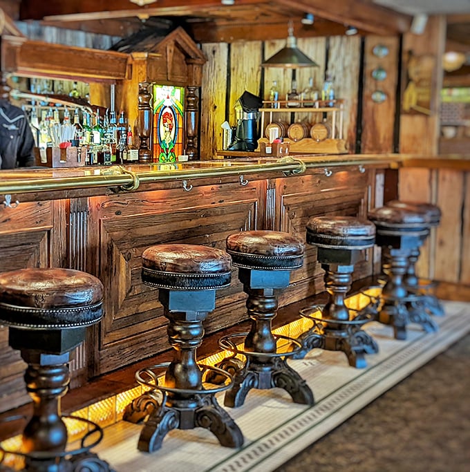 The bar isn't just where drinks are made; it's a wood-paneled sanctuary where leather stools invite you to settle in and forget about tomorrow's diet plans.