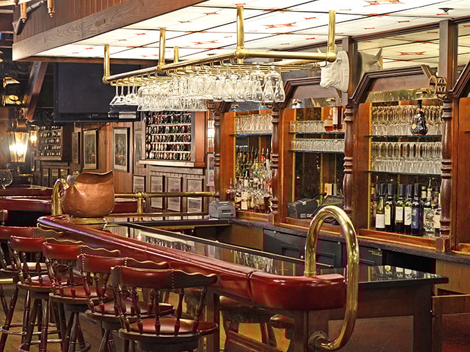 A bar that says "pull up a stool and stay awhile," with gleaming glassware hanging like crystal stalactites ready to catch your favorite spirit.