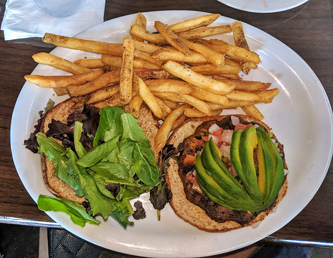 This black bean burger proves meatless doesn't mean flavorless – topped with fresh avocado like nature's own butter.