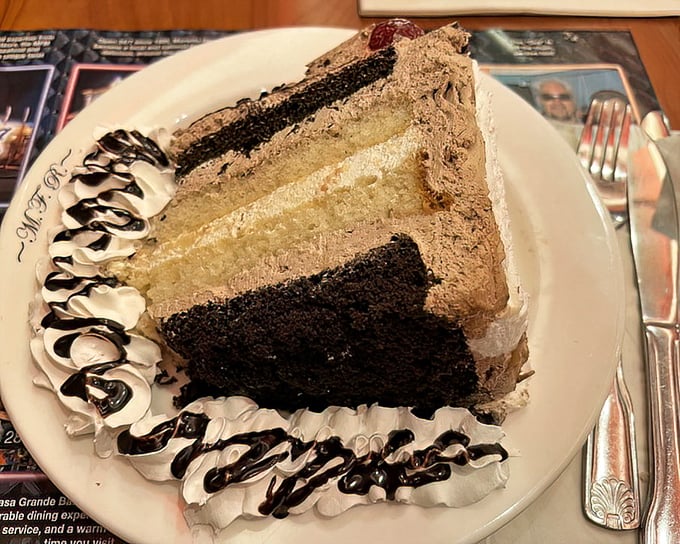 This layered chocolate cake isn't just dessert—it's architecture, engineering, and art all served on a plate that's barely big enough.