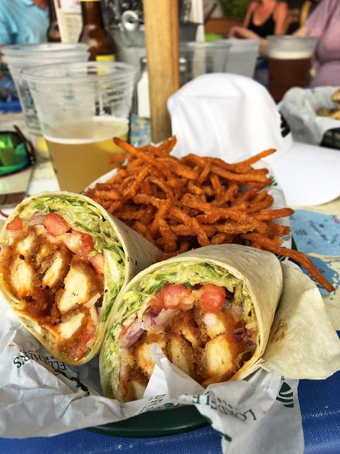 The buffalo chicken wrap with sweet potato fries—lunch that makes you want to call your boss and extend your break indefinitely.