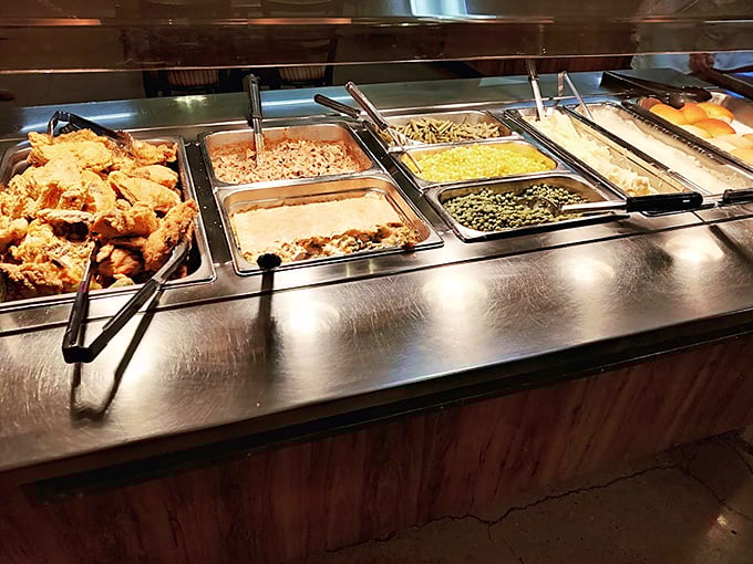 The buffet line – where decisions get tough and plates get full. That fried chicken is practically jumping onto plates by itself.
