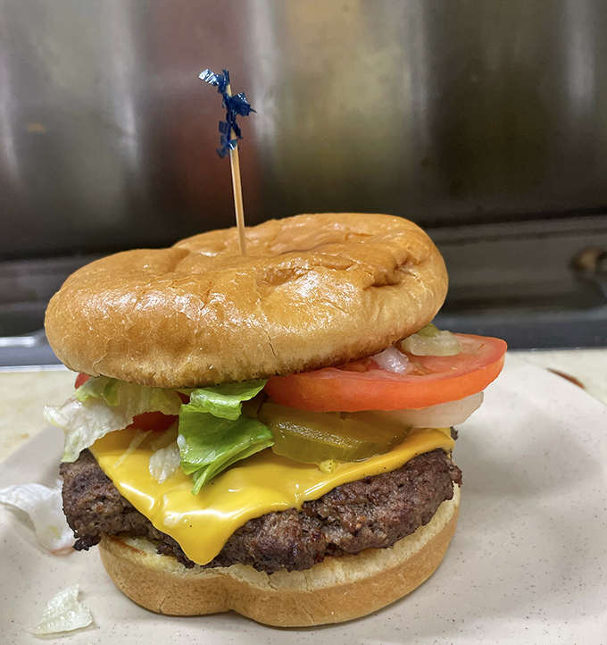 This isn't just a burger – it's a masterclass in simplicity, with a hand-formed patty, melty American cheese, and fresh veggies on a toasted bun.