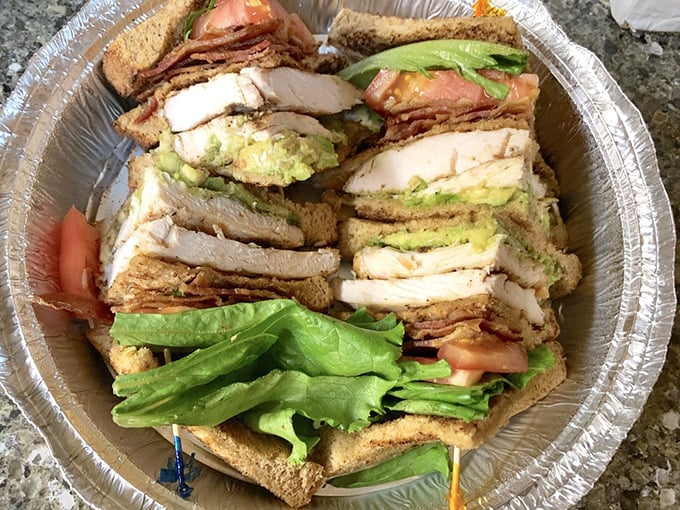 The California Club stands tall and proud – a skyscraper of turkey, bacon, and avocado that requires both hands and possibly an engineering degree.