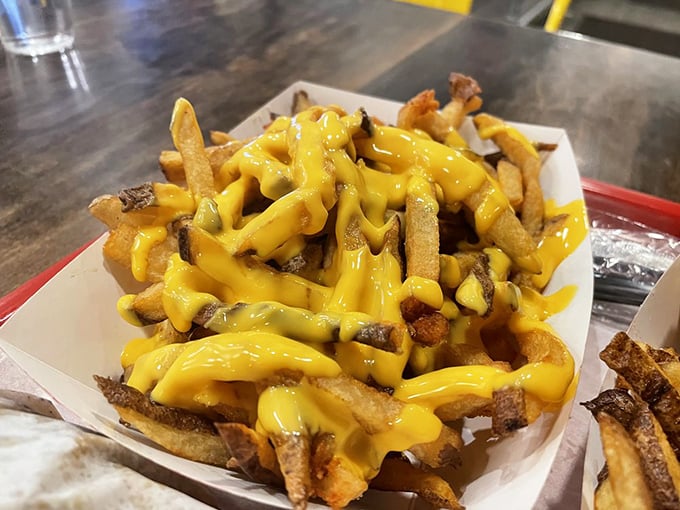 Cheese fries that don't mess around—hand-cut potatoes swimming in a golden cheese sauce that would make Wisconsin jealous.