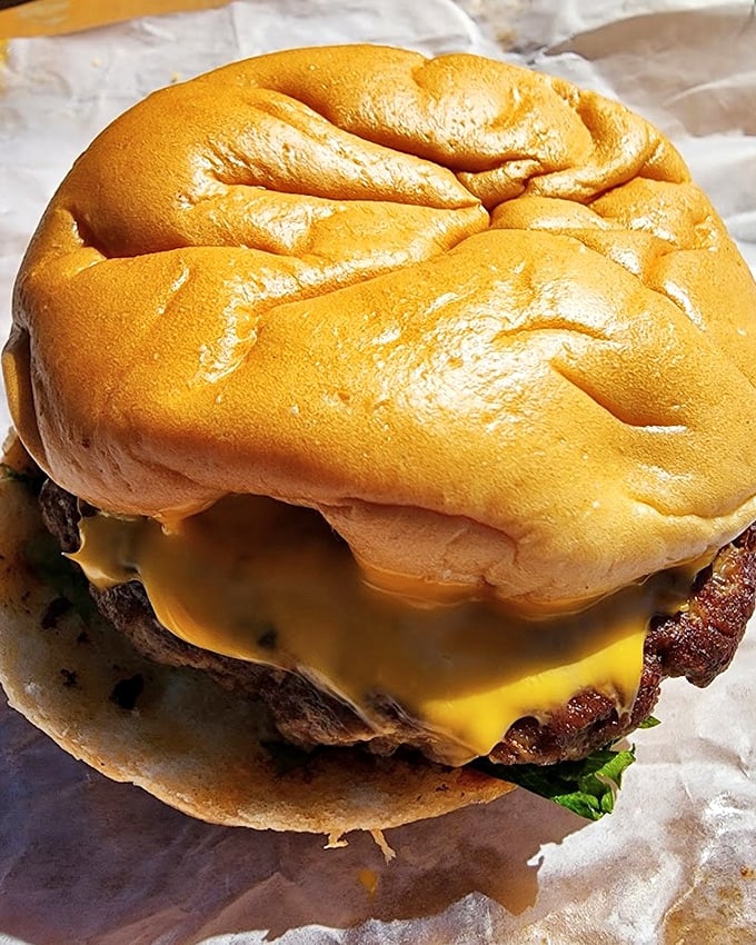 A burger that doesn't try to be trendy – just a properly seasoned patty with melted cheese on a pillowy bun that satisfies a primal hunger.