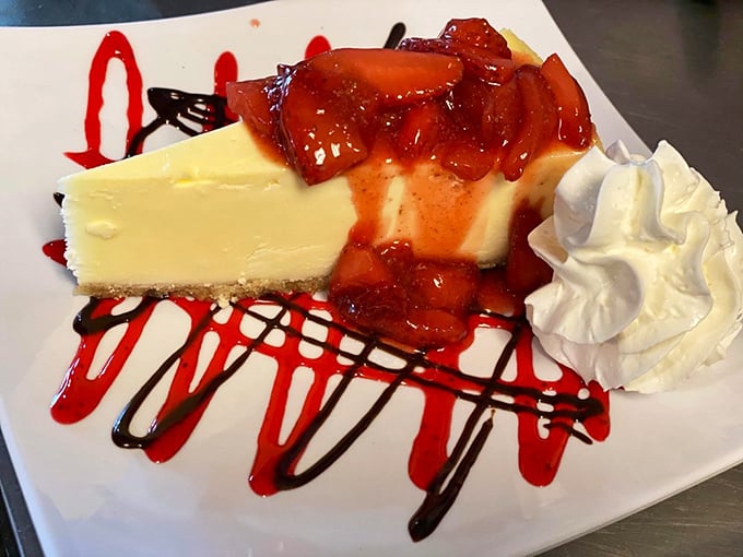 Cheesecake that makes you forget your troubles – creamy perfection topped with berry compote and artistic drizzles that say "calories don't count on vacation."