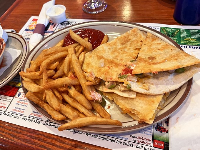 This quesadilla isn't just folded—it's packed with promises. Crispy exterior, melty interior, and a side of fries that refused to be upstaged.