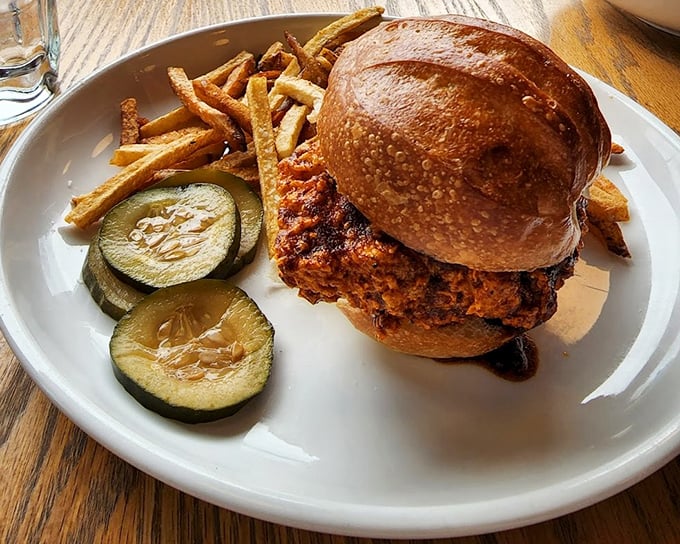 This isn't your average chicken sandwich—it's a towering achievement of crispy, juicy perfection nestled in a golden bun with house pickles.