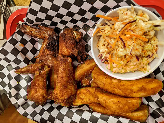 The perfect chicken wing trifecta—smoky, crispy, and juicy—served with slaw that cuts through the richness like a refreshing breeze.